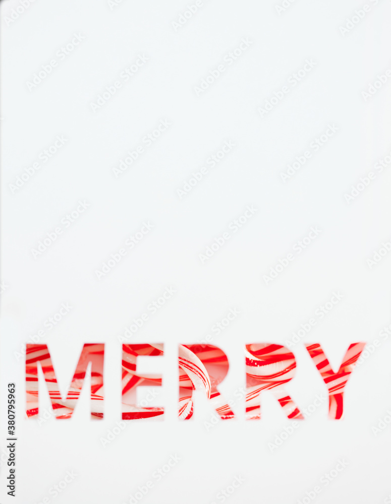 Words: Candy Canes Seen Through The Word ""Merry"" Cut Out Of Paper ...