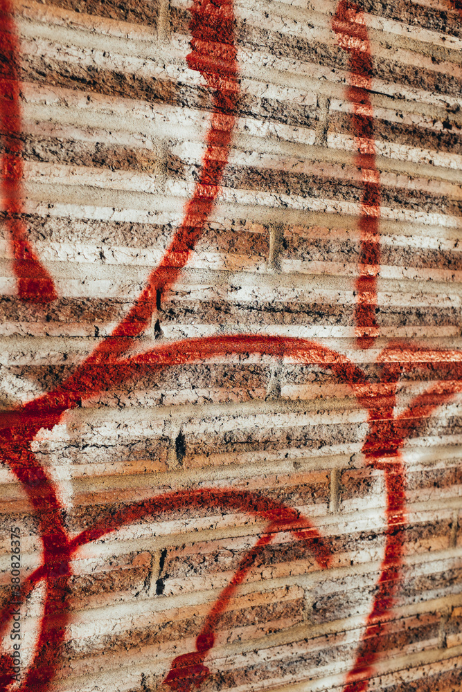 Spray painted graffiti lettering and marks on building wall Stock Photo ...