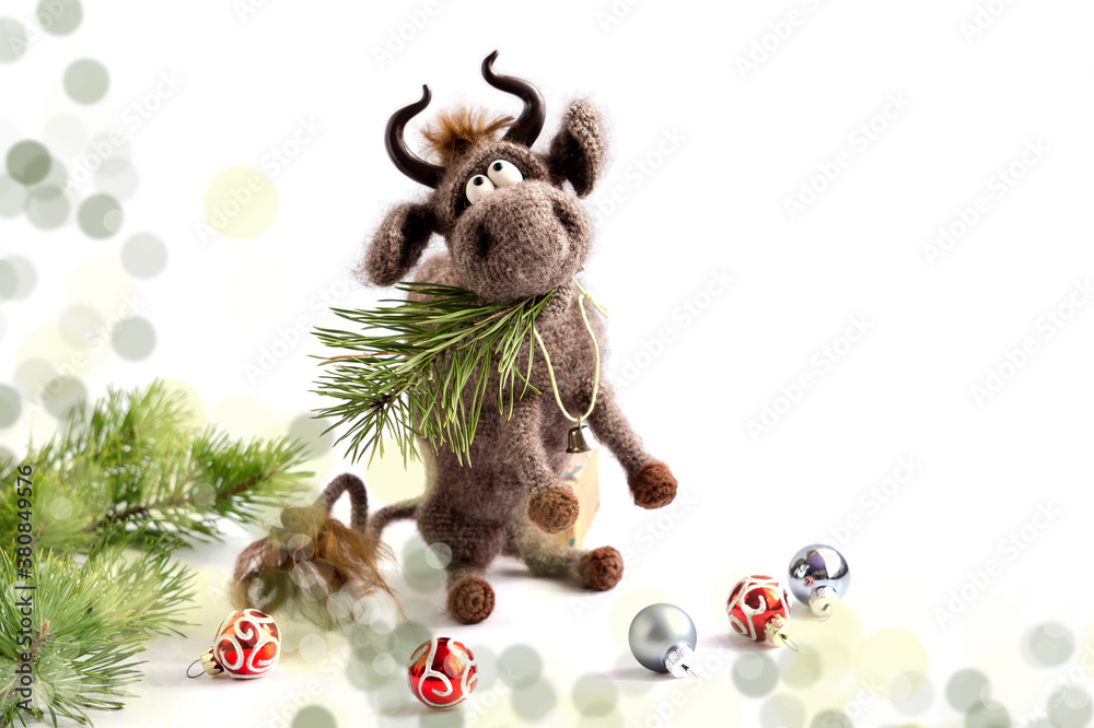 Toy bull. The bull is a symbol of the new year 2021. A knitted brown ...