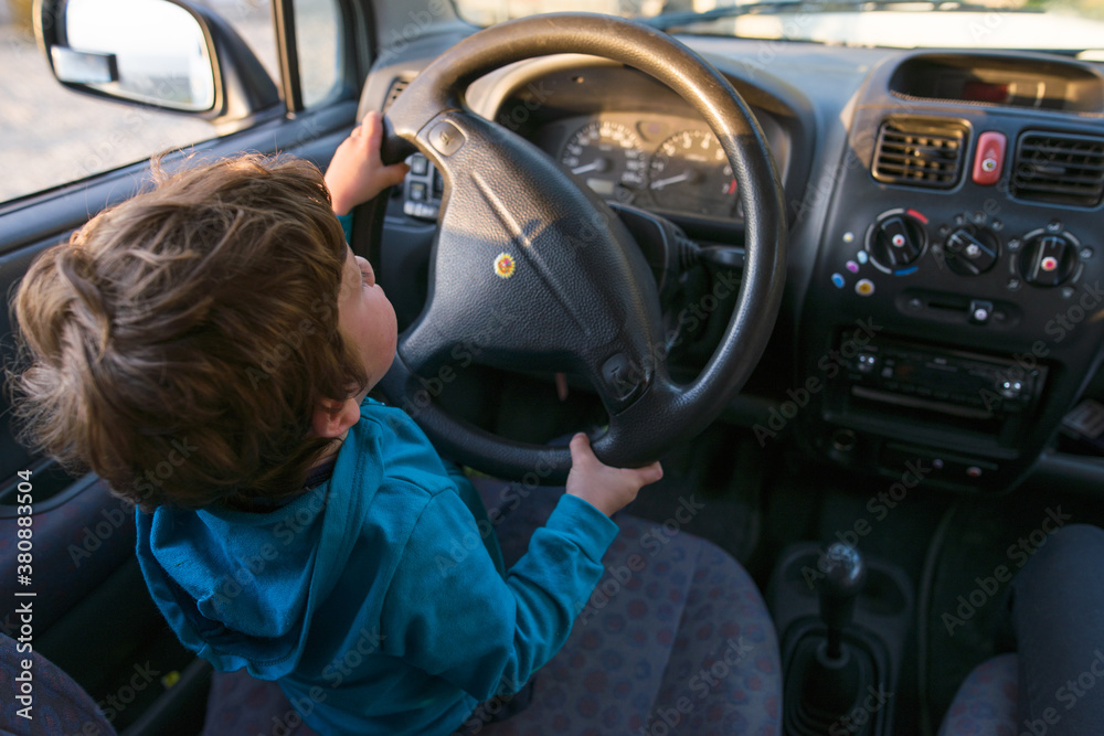 Little boy driving his father's car Stock Photo | Adobe Stock
