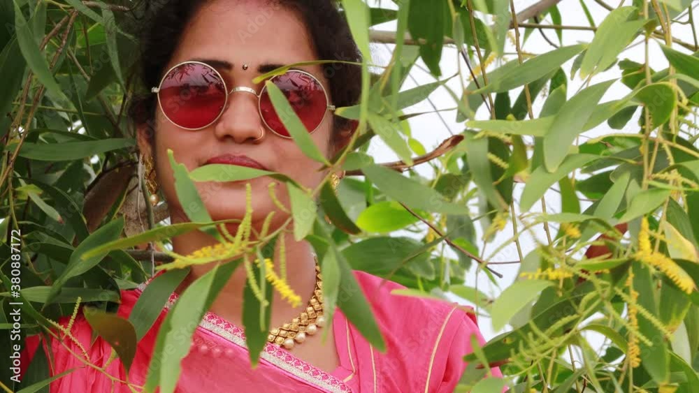 A beautiful Indian young woman enjoying the nature standing in the ...