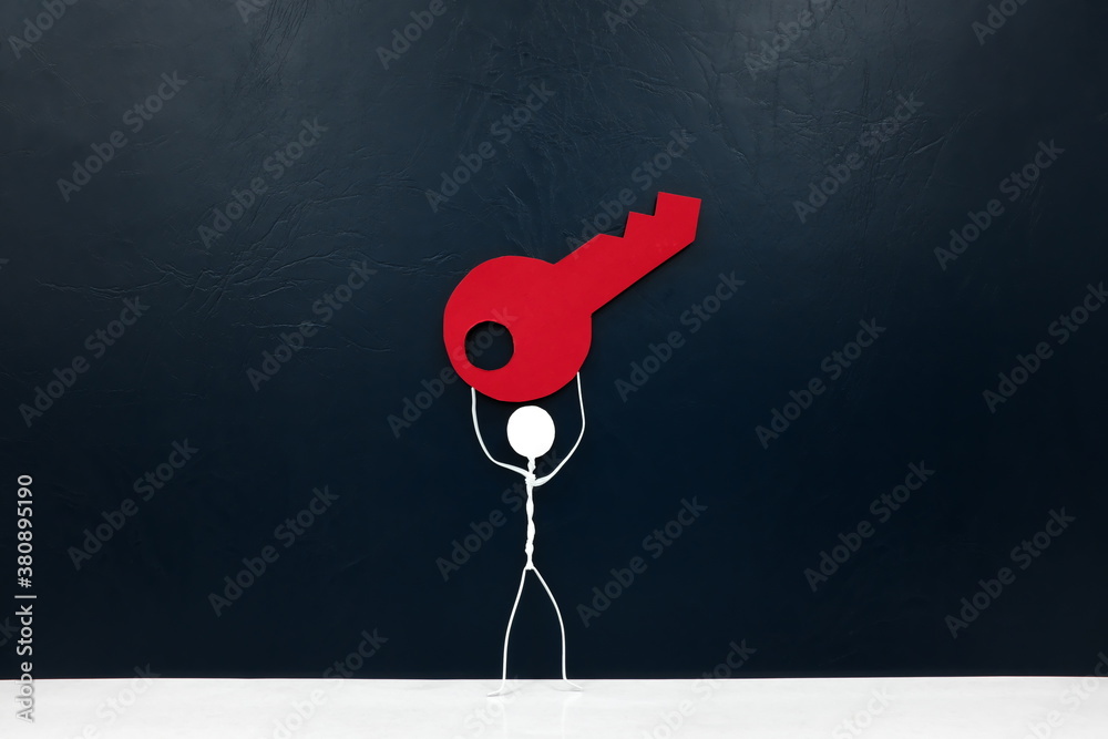 Stick man figure carrying a big red key in dark background with copy ...