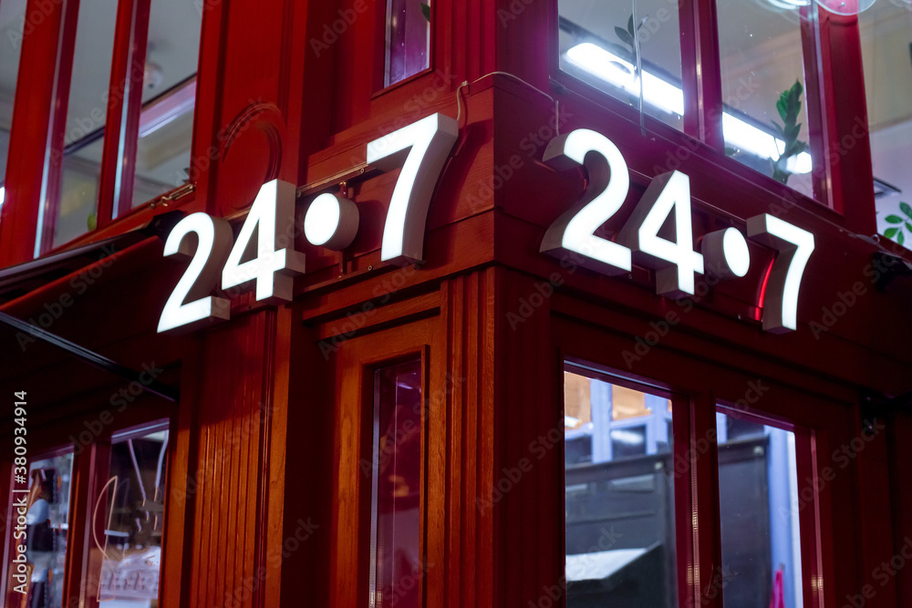 red store on the corner with a luminous sign 24/7, English style red ...