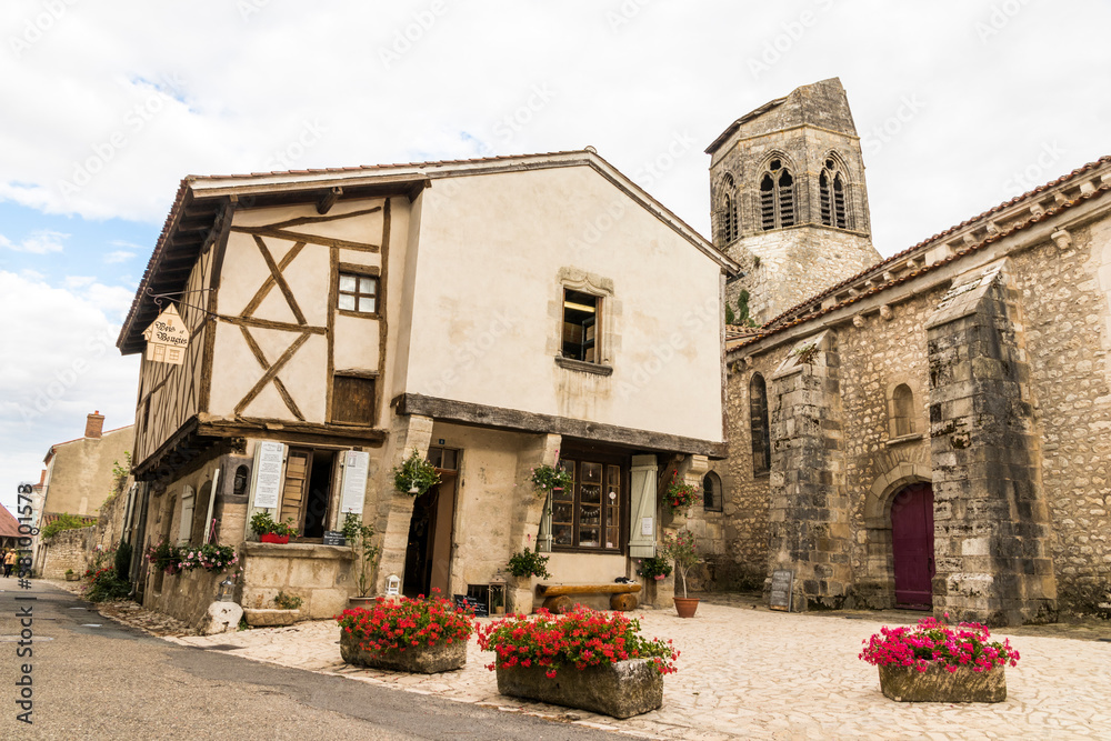 Charroux, France. Half-timbered house and church tower in one of the ...