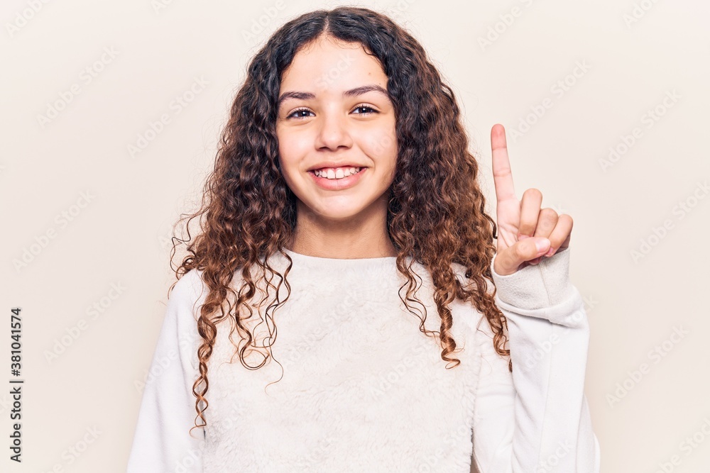 Beautiful kid girl with curly hair wearing casual clothes smiling with ...