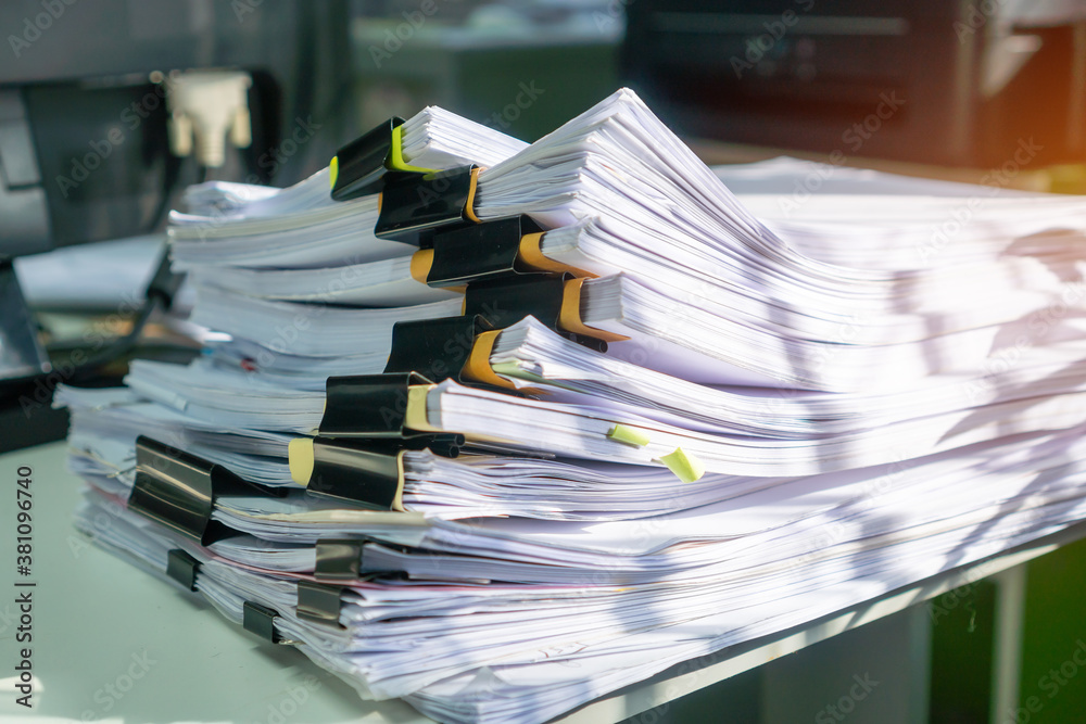 Stack of insurance paperwork documents information of finance files on ...