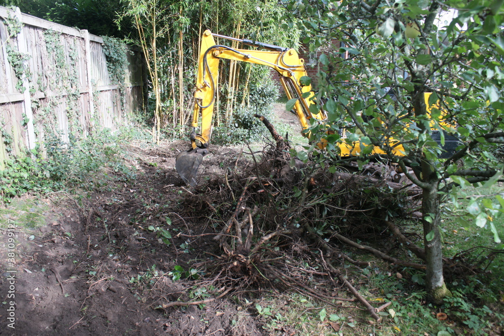 Yellow digger heavy motor machinery with digging arm moving earth, re ...