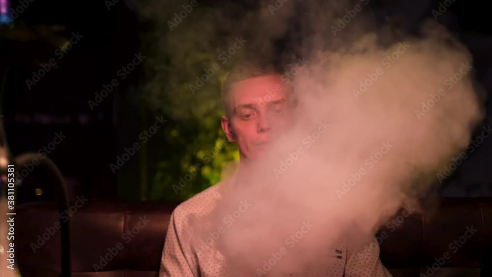 Vidéo Stock Caucasian man exhaling a fog cloud and chilling. Media ...