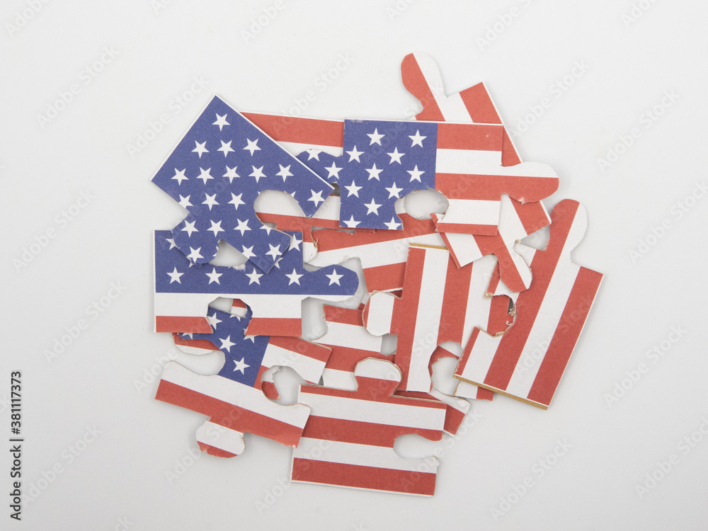 Jigsaw puzzle with picture of American flag in pieces in front of white ...