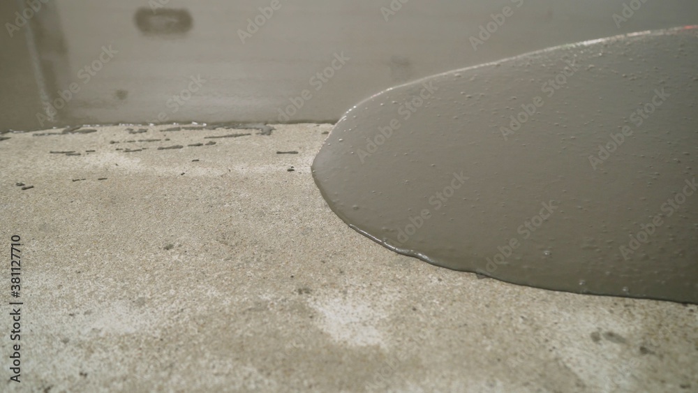 Pour the liquid floor onto the concrete surface. Leveling the floor ...