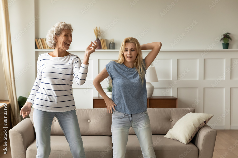 Funny relax. Younger and elder women of two different generations, aged ...