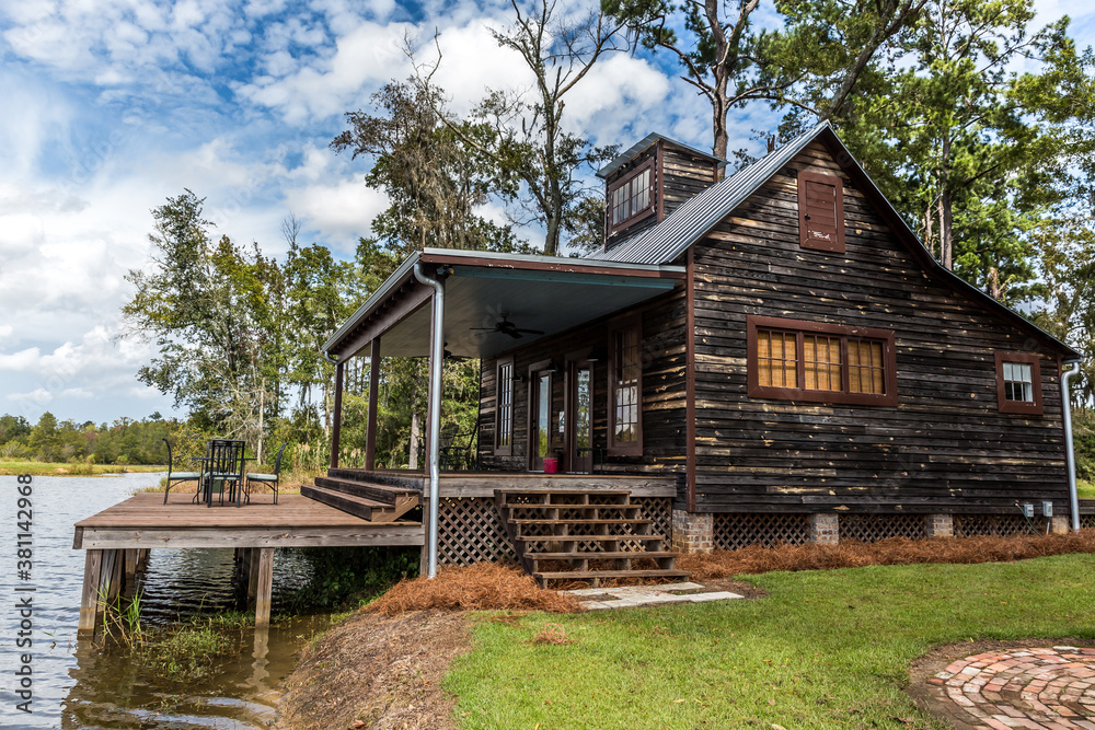 Scenic side view of the exterior of a rural rustic wooden camp house ...