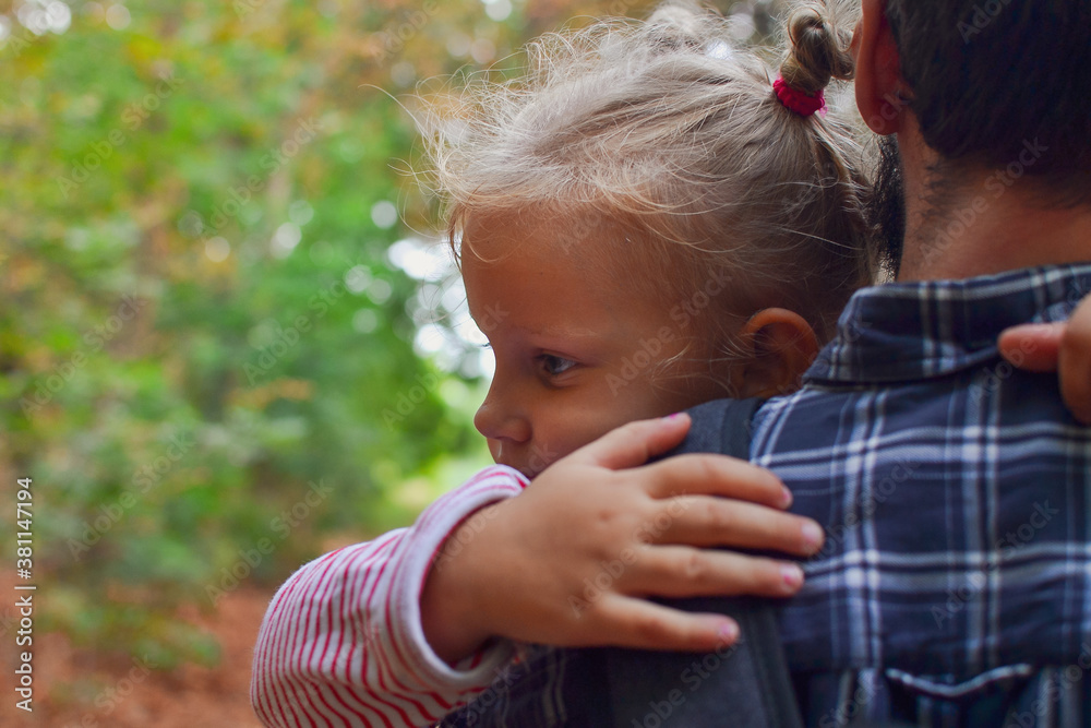 The baby hugs dad. Father holds a cute little girl in his arms. Autumn ...