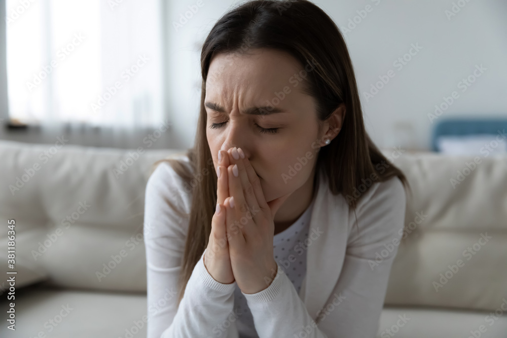 Upset desperate young woman hold hands in prayer feel religious ...