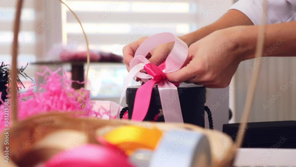 Gifts wrapping close-up. Designer of gifts and decorations decorates ...