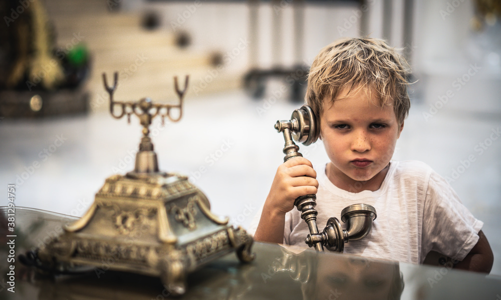 Boy take telephone receiver, play with antique vintage rotary old ...