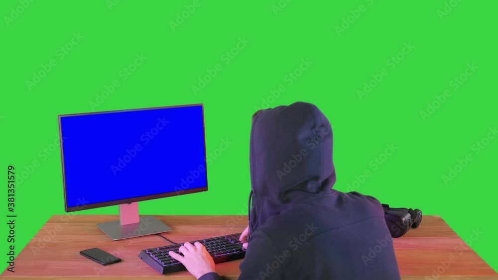 Hacker in hood cracking code using pc on a Green Screen, Chroma Key ...