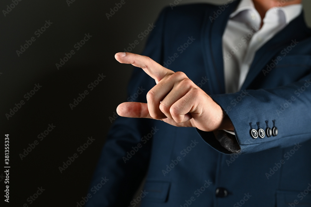 The man holds his index finger in front of him. A man in a suit points ...