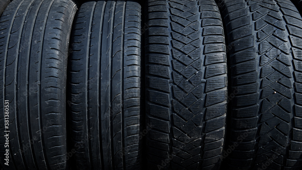 Stack of used tires at the car service waiting for disposal. Worn out ...