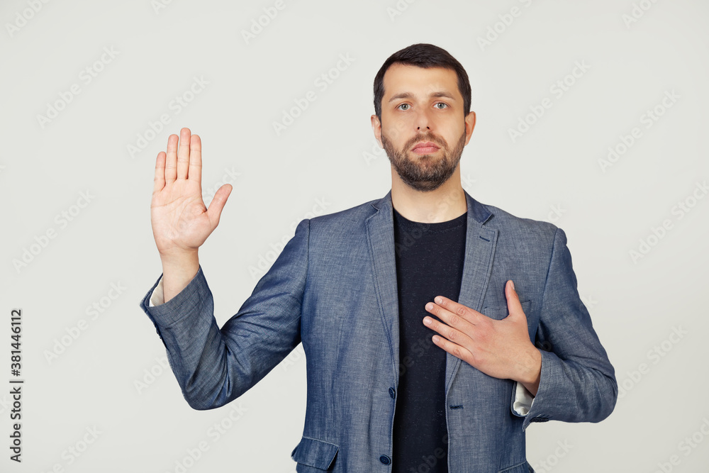 Young businessman man with a beard in a jacket, swears, putting his ...