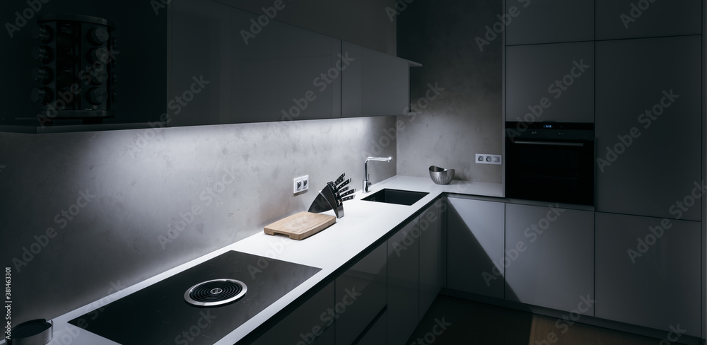 Modern kitchen in minimalist design during night with LED light strip ...