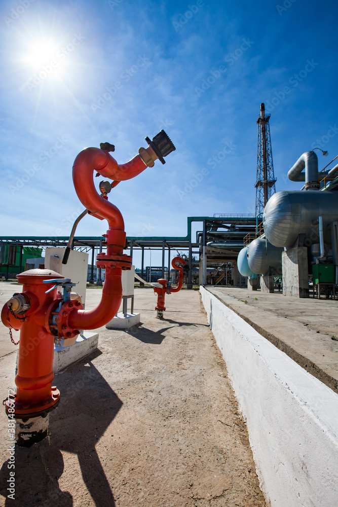 Petrochemical plant. (Oil refinery plant). Red fire extinguisher and ...