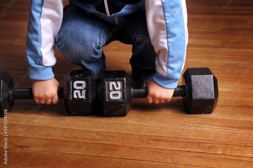 Little Girl Trying to Lift Heavy Dumbbell Weights to Workout, Fitness ...