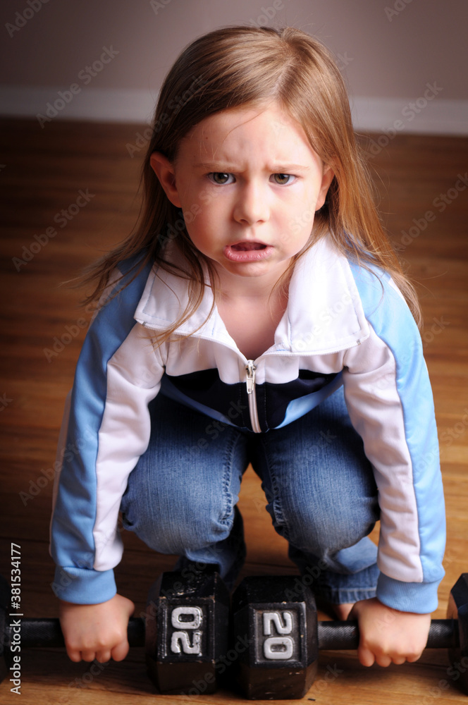 Little Girl Trying to Lift Heavy Dumbbell Weights to Workout, Fitness ...