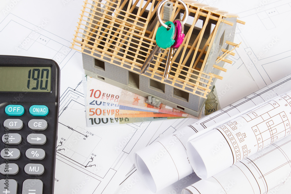 Foto de House under construction, keys, calculator and currencies euro on electrical drawings ...