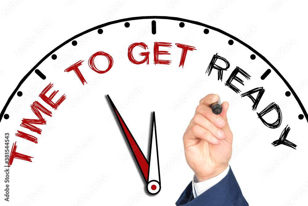 Hand writing TIME TO GET READY on drawn clock with marker on ...