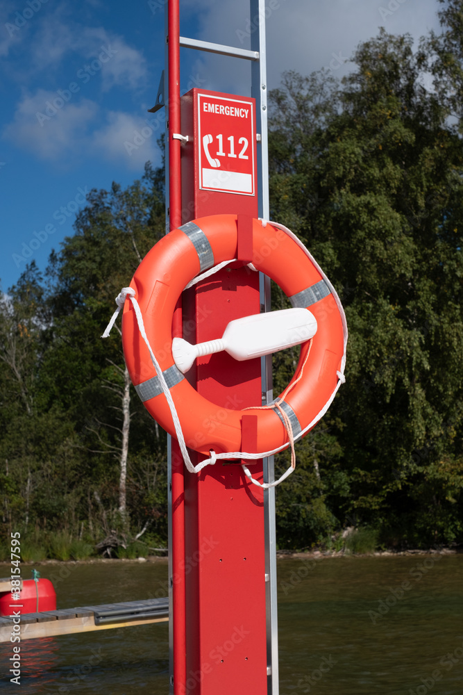 Life preserver or lifebuoy installed on a dock for emergency use in ...