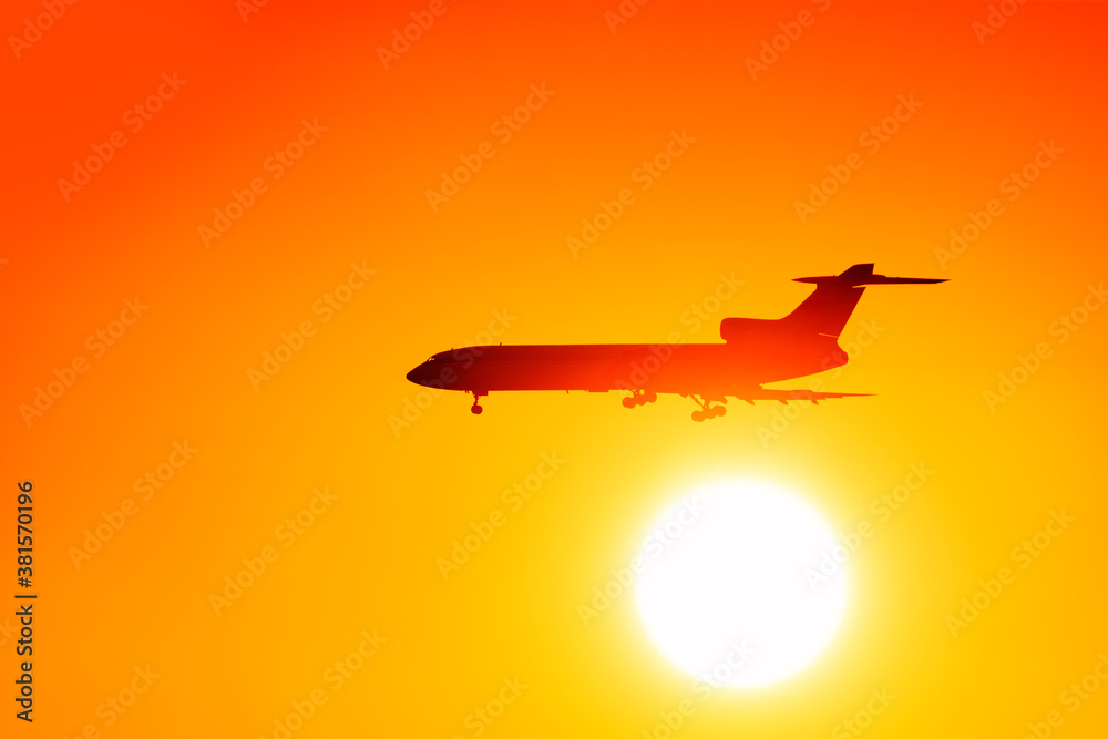 jet airplane flying against sunset sky background. Passenger plane ...