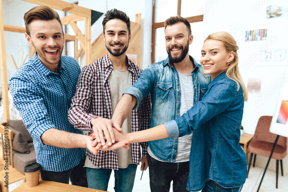 Designers look at the camera and act like a team. Stock Photo | Adobe Stock
