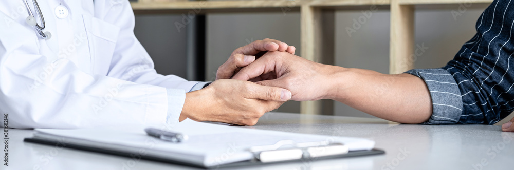 Close up of doctor touching patient hand for encouragement and empathy ...