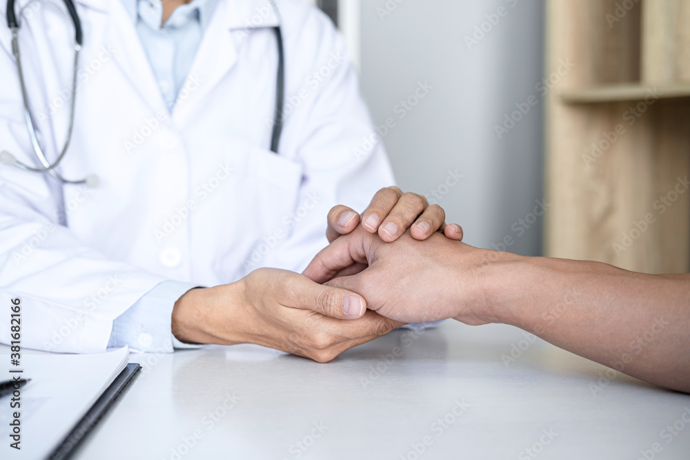 Close up of doctor touching patient hand for encouragement and empathy ...