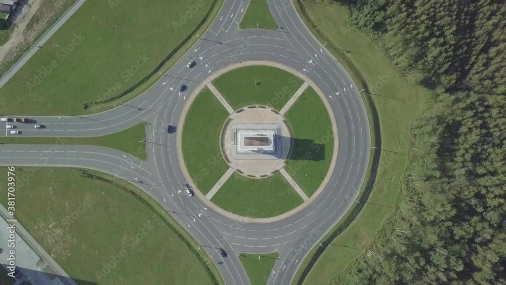 An unmanned camera rotates around a circular traffic ring on a city ...