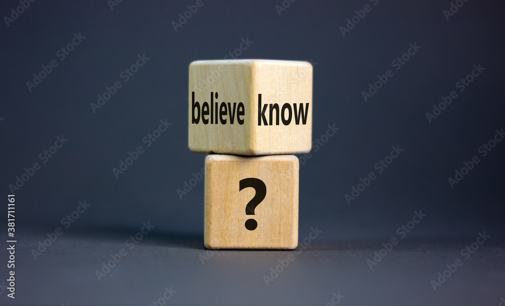 Conflict of knowing or believing. Wooden cubes with words 'believe' and ...