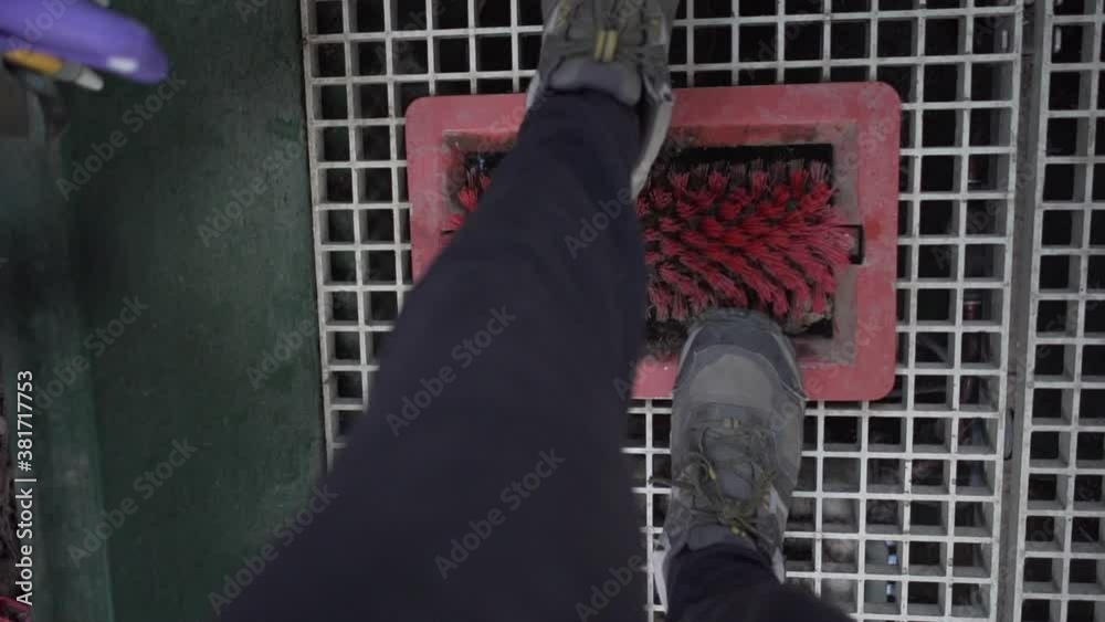 Traveler's Feet Removing Dust Off The Shoes On A Red Foot Brush ...