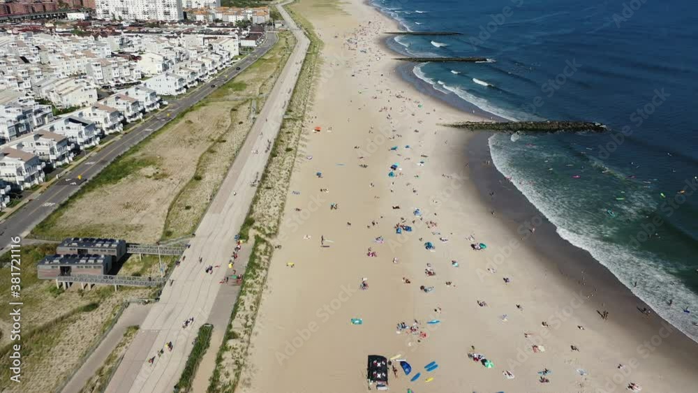 An aerial view of a beach during a sunny day. The camera dolly in ...
