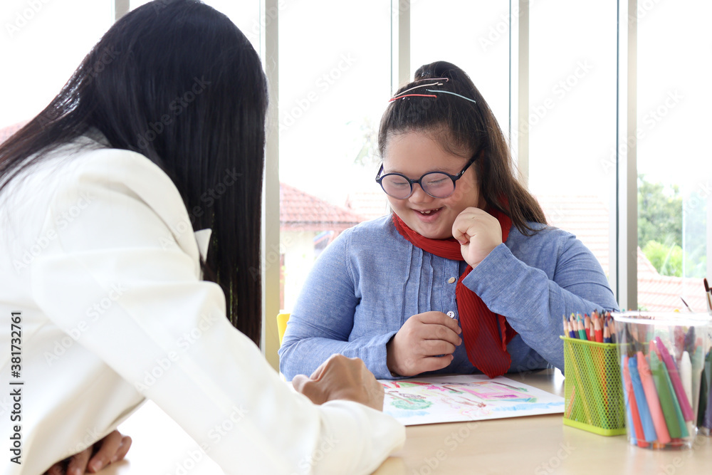 Disabled kids classroom, down syndrome children try to focus on lesson during study at school ...