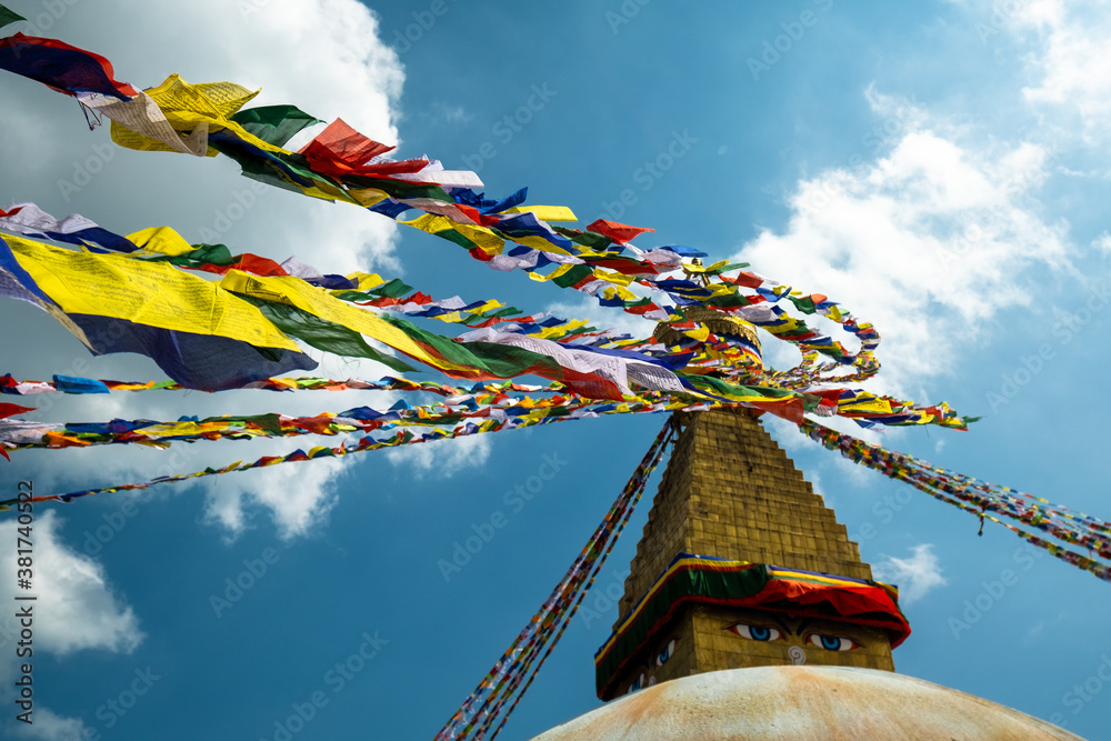 Multicolored Buddhist prayer flags with mantras on a background of blue ...
