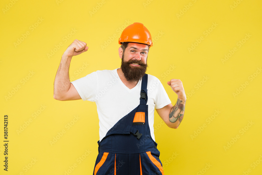 Power building. Strong construction man flex arms yellow background ...