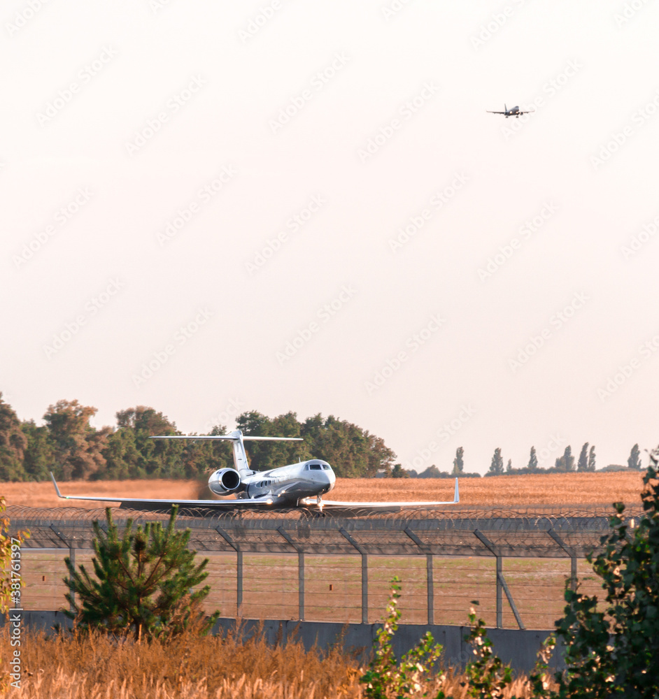 Private jet just touched down the runway in the dusk. Airplane making ...