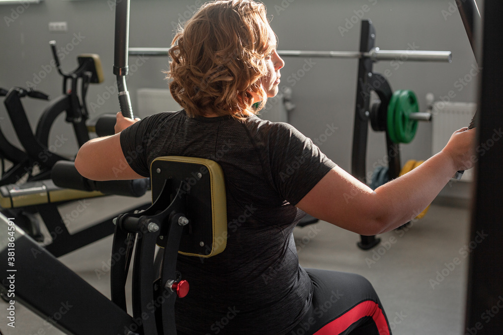 Fat woman fights overweight in the gym, doing heavy fitness exercises ...