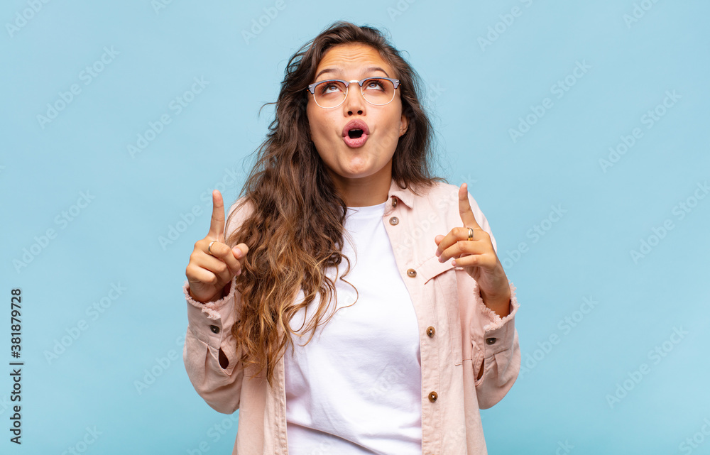 feeling awed and open mouthed pointing upwards with a shocked and ...