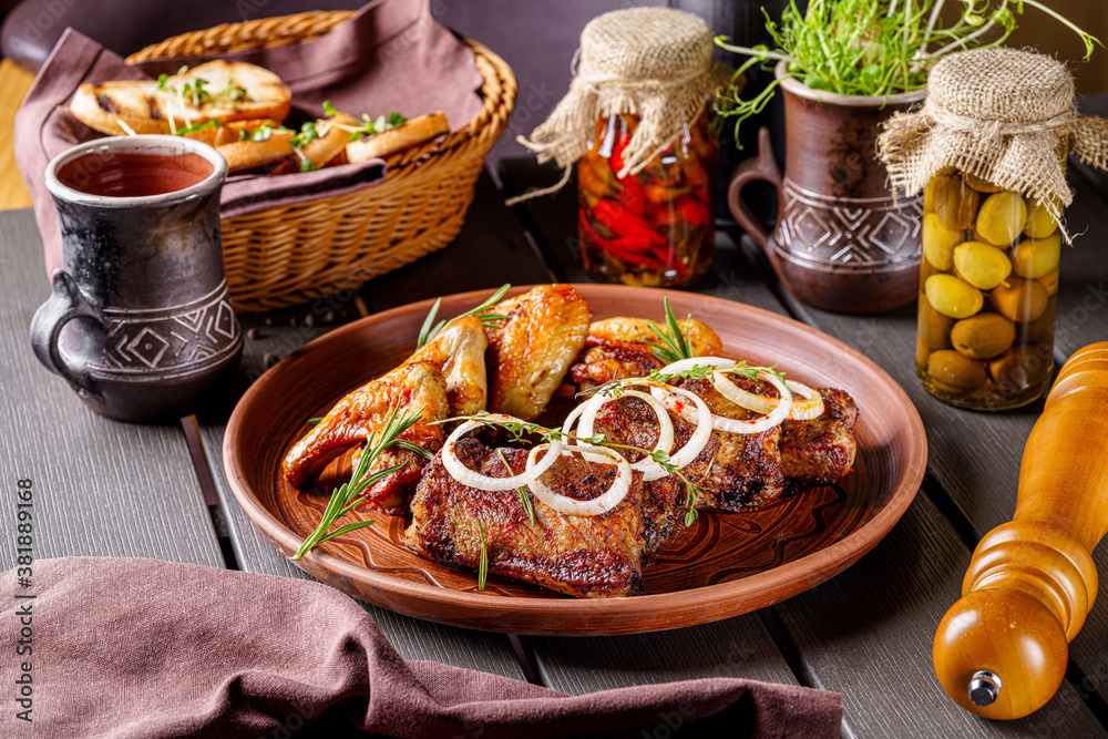 Turkish cuisine. Fried wings and lamb ribs are on the plate. Serving ...