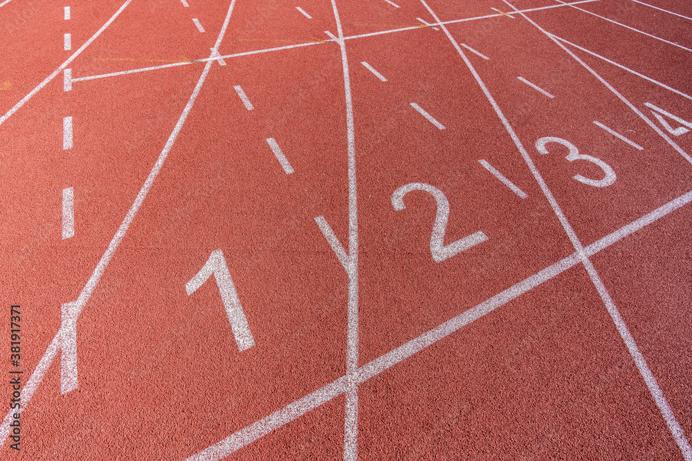 White painted lines and numbers on a running track in a athleticism and ...