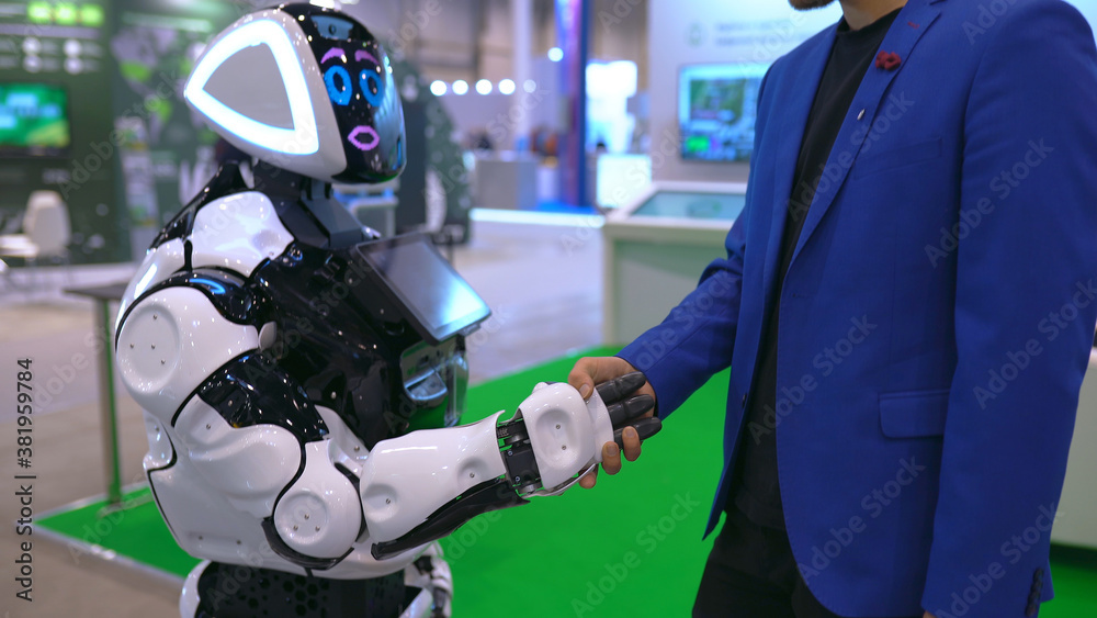 People greet robot hand shake close up learning etiquette 4K. Man in ...