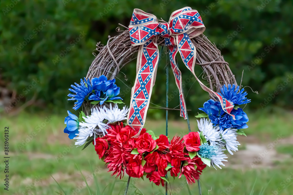 A wreath of blue, white and red flowers with Confederate flag themed ...