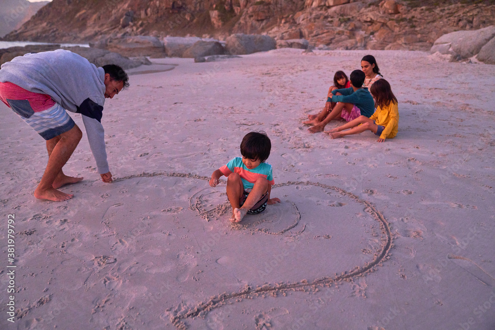 Family drawing in sand on beach Stock Photo | Adobe Stock
